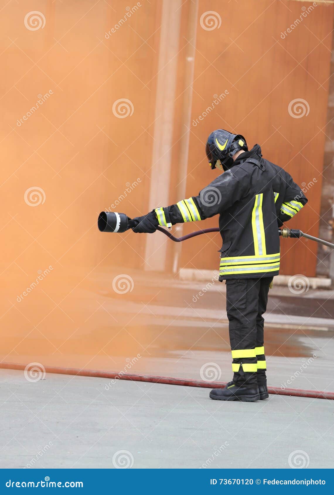 Fireman with an Extinguisher Under the Orange Smoke Stock Photo - Image ...
