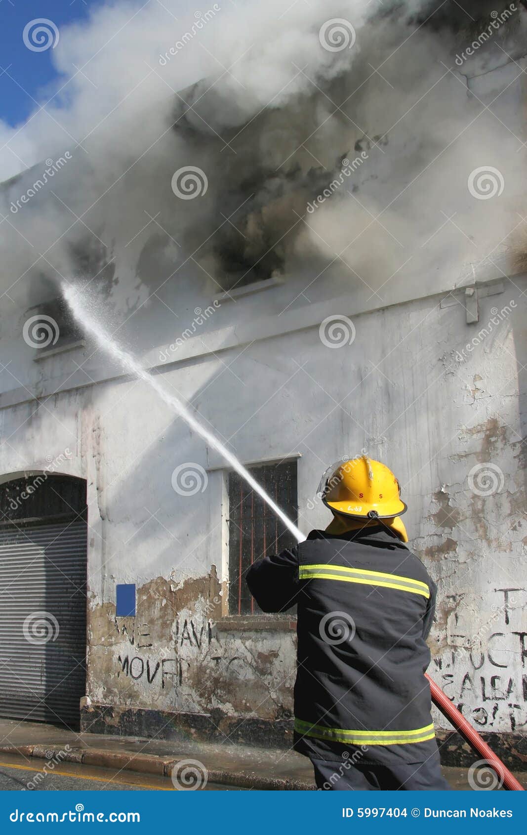 Fireman Fighting Fire stock photo. Image of derelect, hose - 5997404