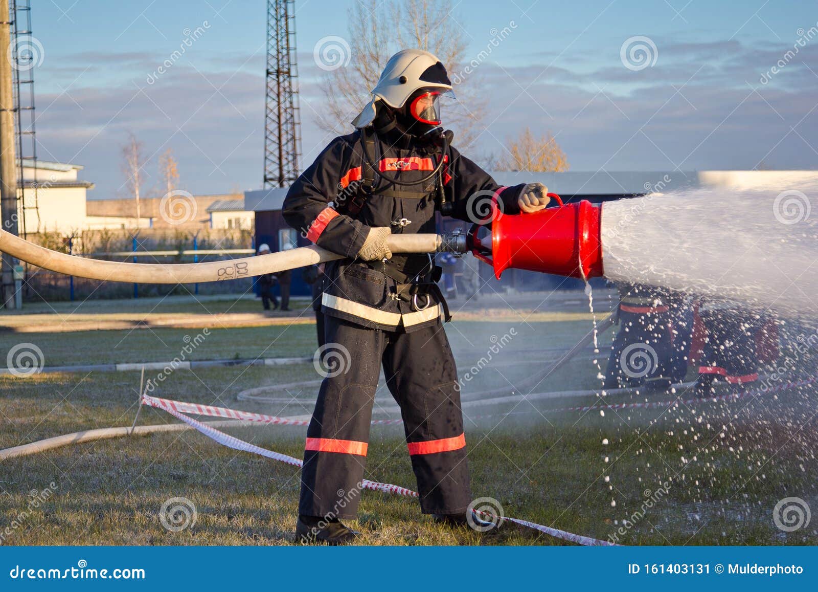 Fireman with Fire Extinguishing Foam Spraying Hose Stock Image - Image ...