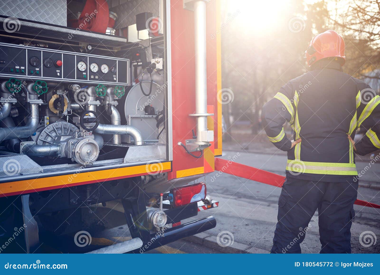 Fireman Firefighter in Action Standing Near a Fire Truck. Attack ...