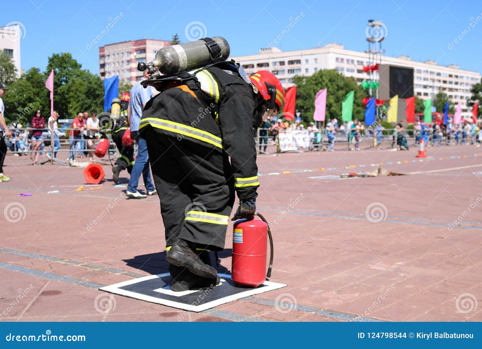 A Fireman in a Fireproof Suit and a Helmet Runs with Red Fire ...