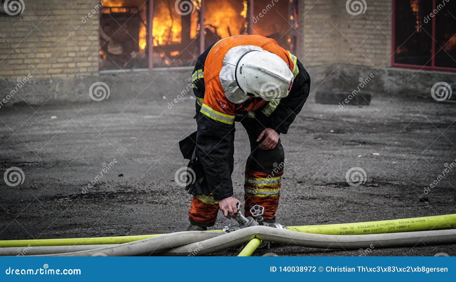 Firefighter Using Equipment Stock Photo - Image of fireman, worker ...