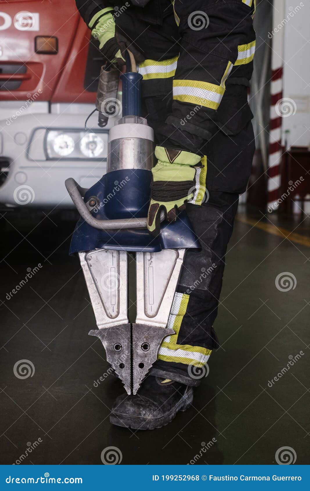 Fireman Holding a Pair of Pneumatic Scissors in a Fire Station Stock ...
