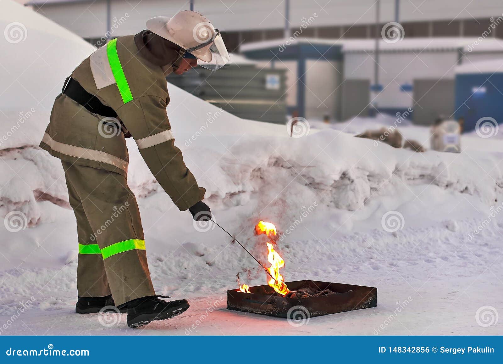 Fireman Makes a Fire Outdoors. Training the Pressure of the Open Fire ...