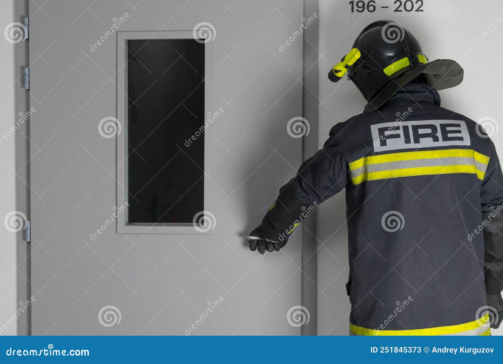 A Fireman Opens the Front Door in the Entrance, Rear View Stock Image ...