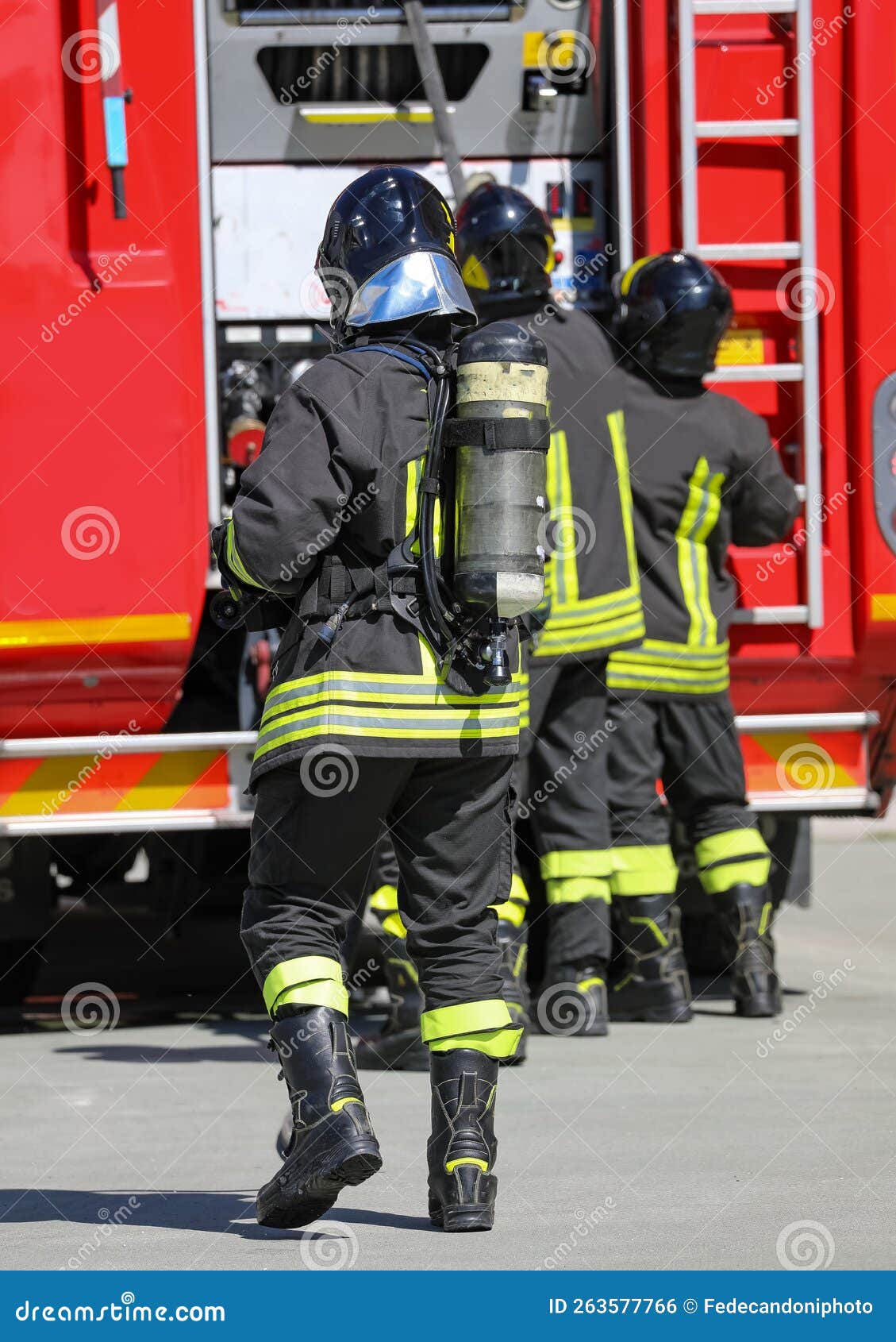 Fireman with Oxygen Tank and Fire Truck in the Background Stock Photo ...