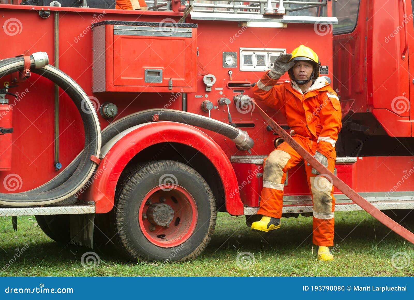 The Fireman is Preparing To Put Out the Fire at the Fire Engine ...