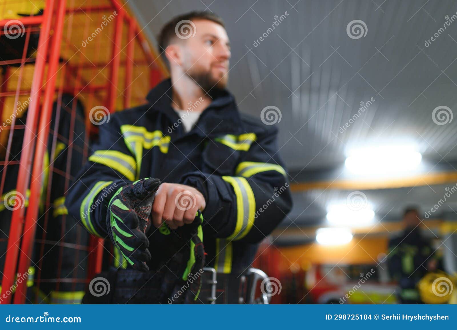 Fireman Putting on Protective Uniform and Preparing for Action while ...