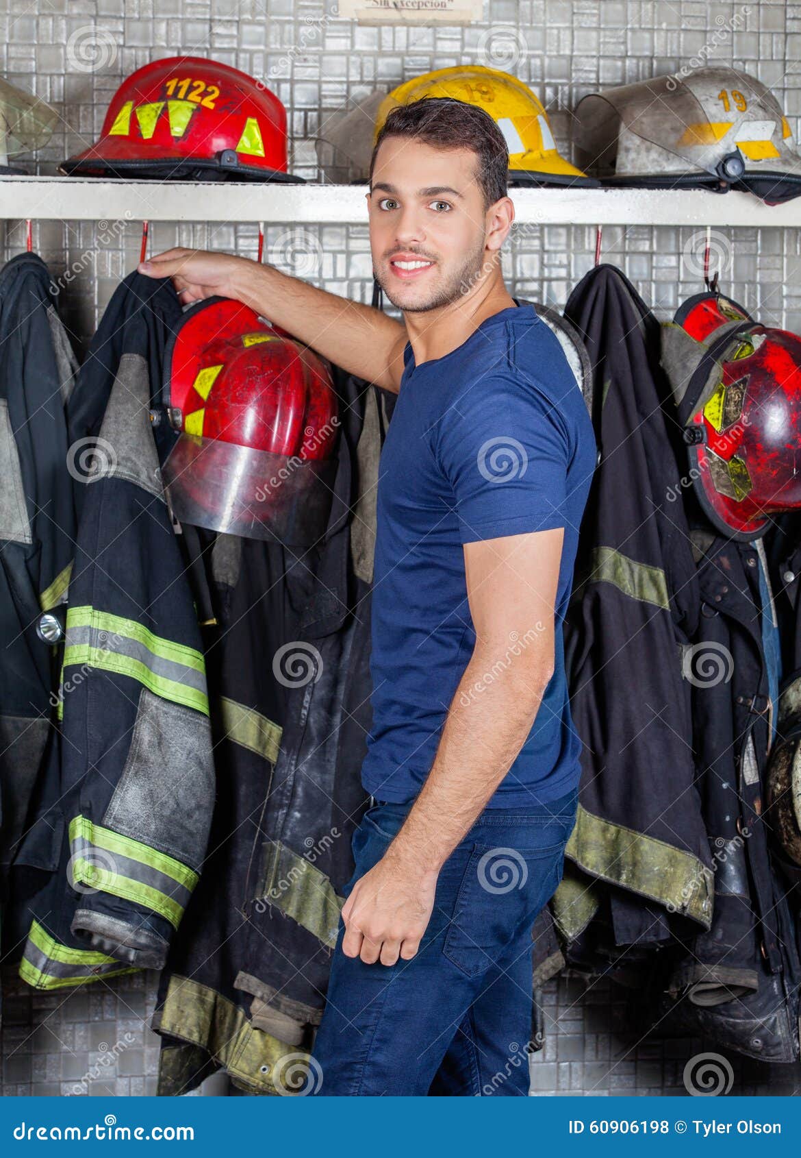 Fireman Removing Uniform Hanging at Fire Station Stock Photo - Image of ...
