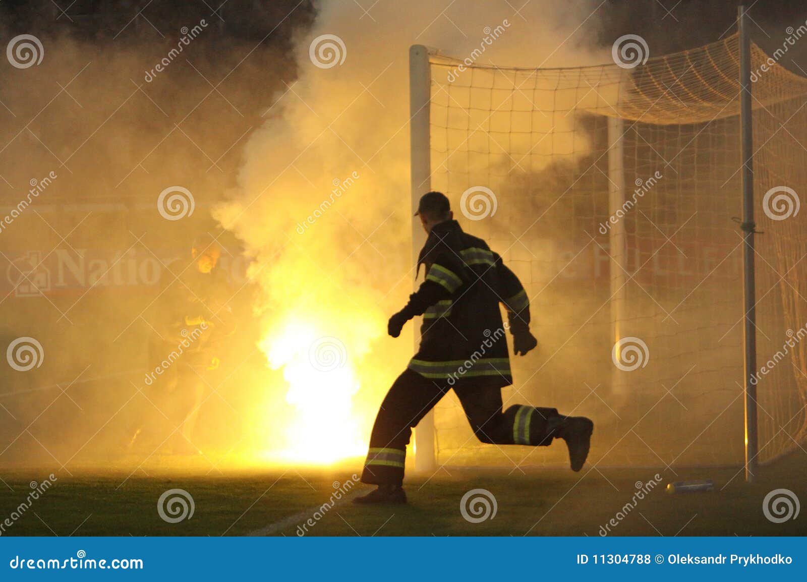 Fireman runs among flairs editorial stock photo. Image of audience ...