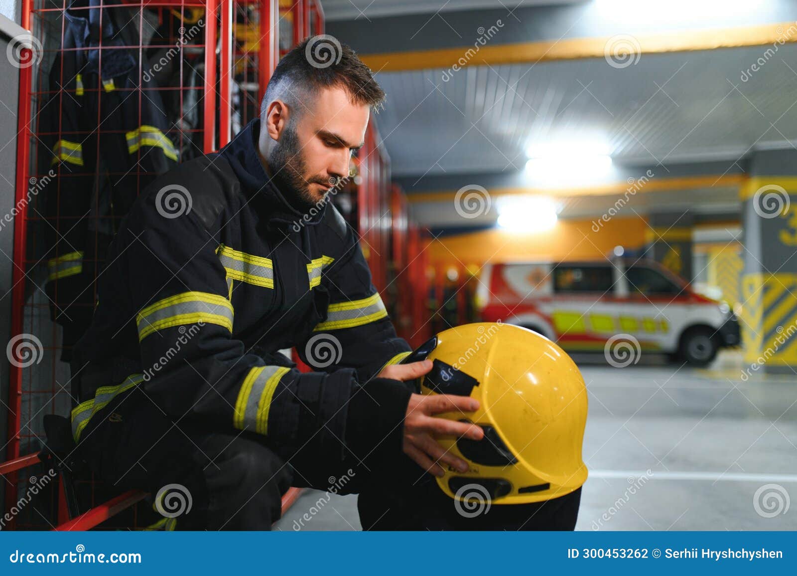 Fireman Sitting on Bench at Fire Station Stock Photo - Image of ...