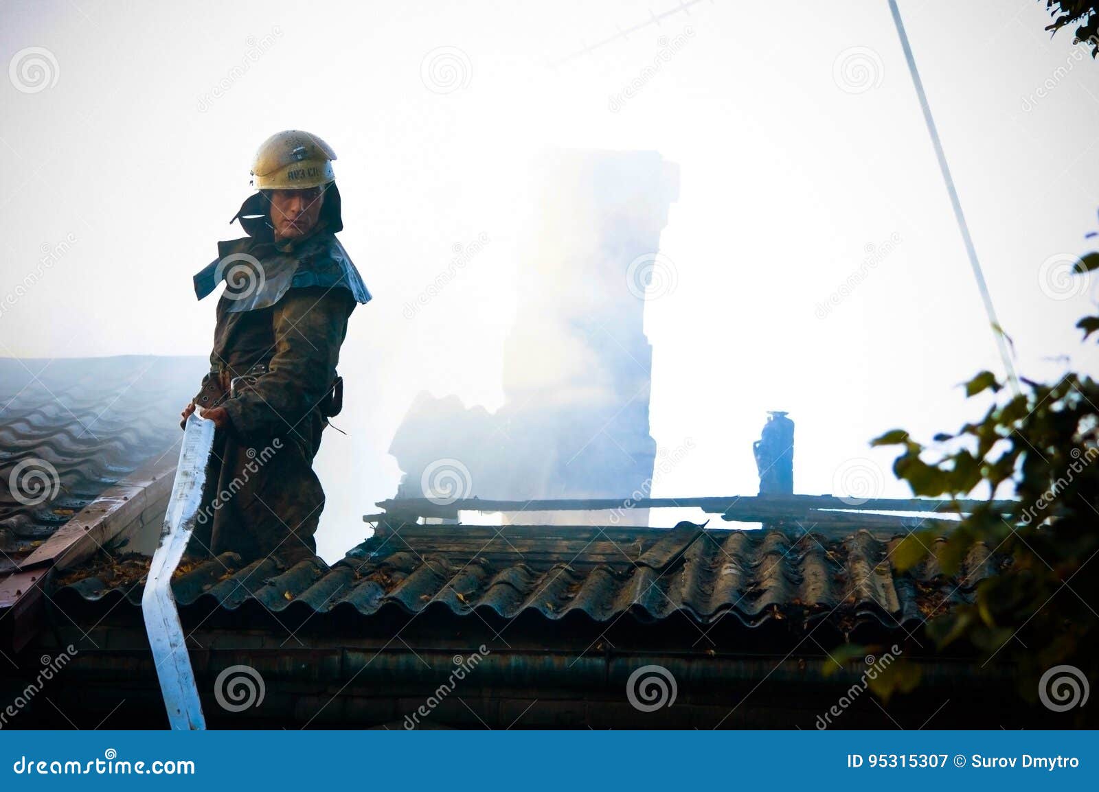 Fireman in a Special Form on the Roof of a Burning House Editorial ...