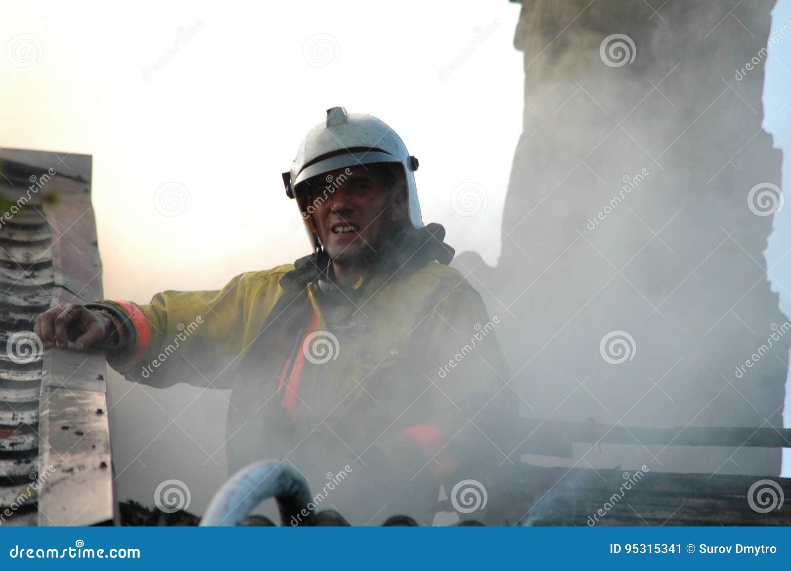 Portrait of Fireman in a Special Form on the Roof of a Burning House ...