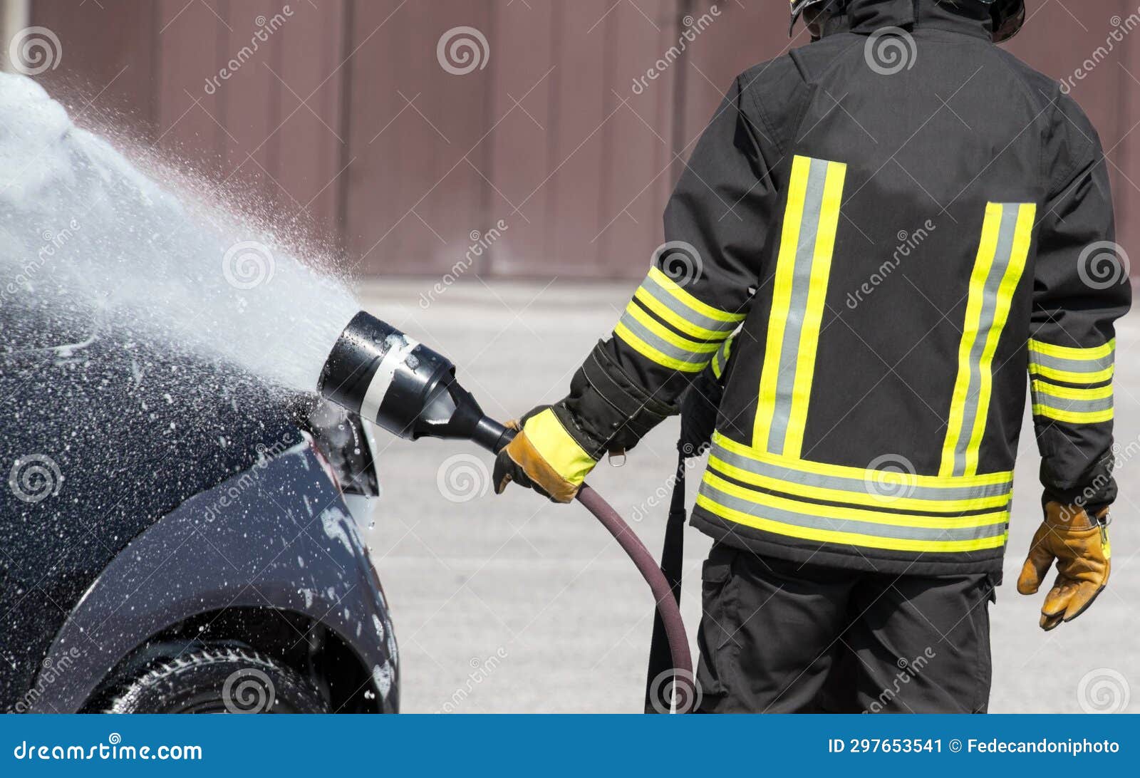Fireman in Uniform with Helmet Puts Out the Fire Using White Foam Stock ...