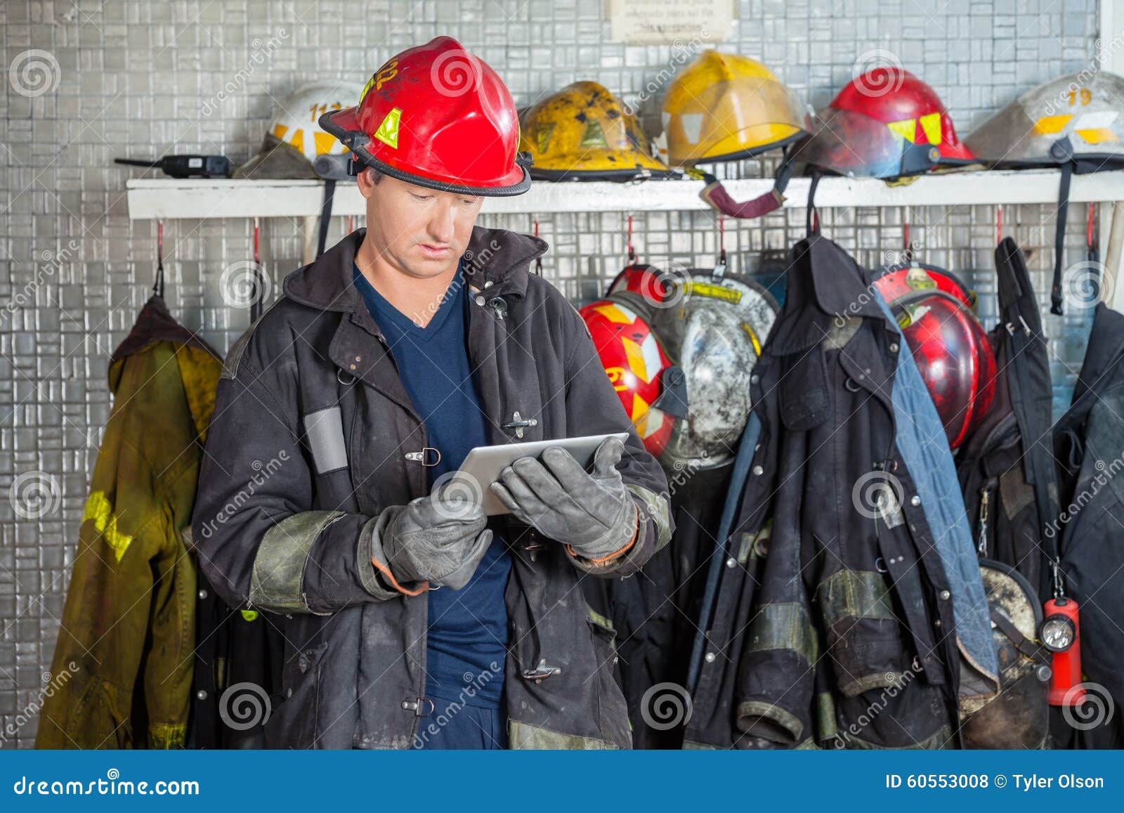 Fireman Using Digital Tablet at Fire Station Stock Photo - Image of ...