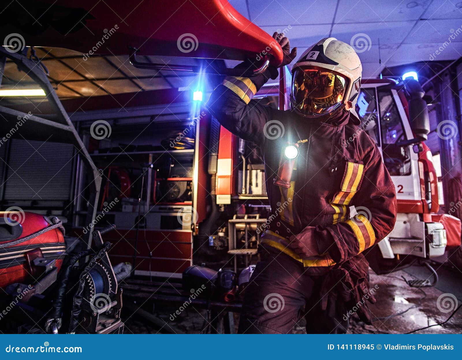 A Fireman Wearing a Protective Uniform with Flashlight Included Working ...