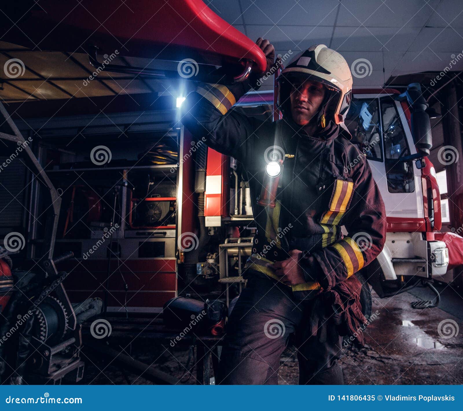 A Fireman Wearing a Protective Uniform with Flashlight Included Working ...