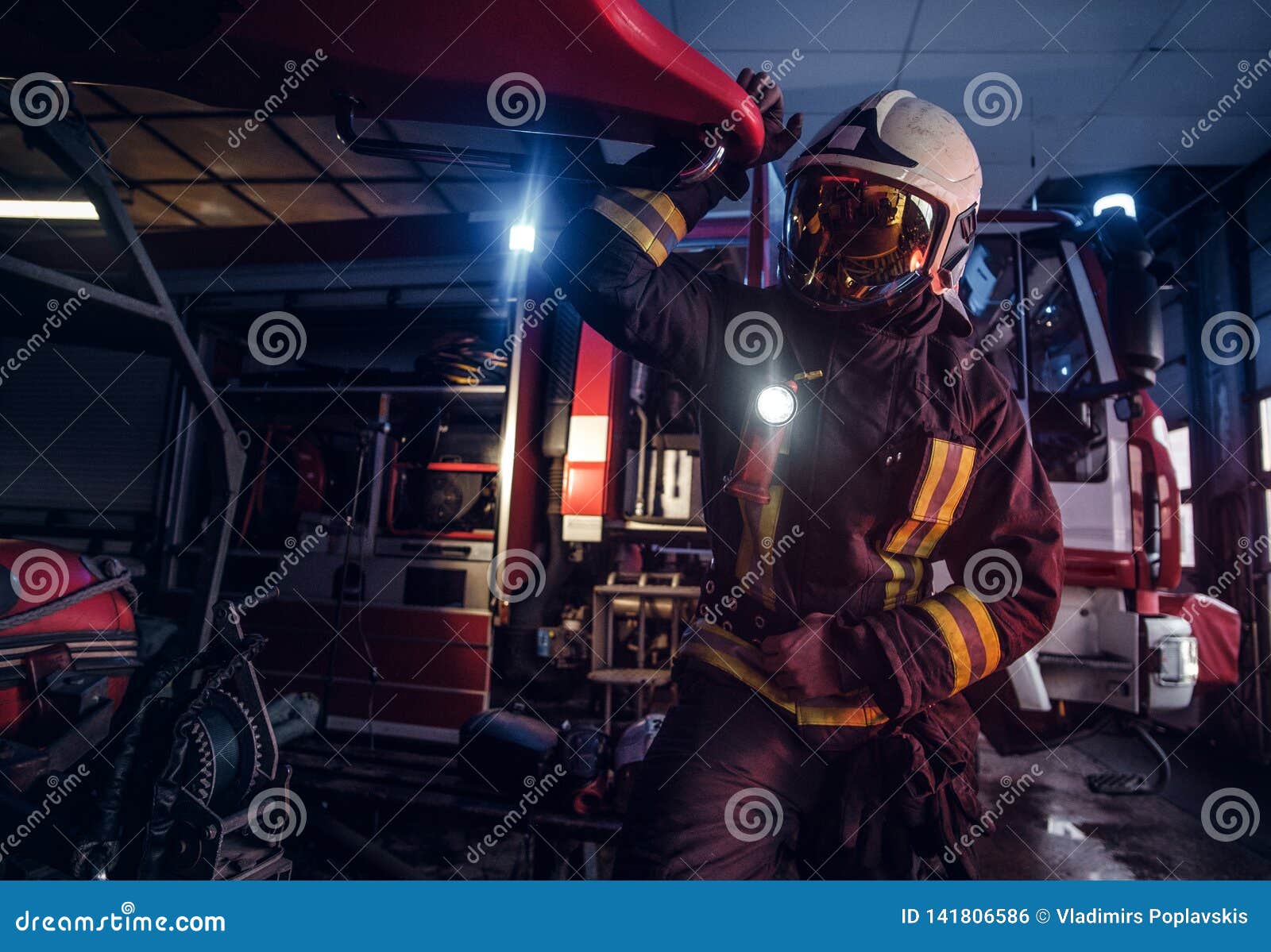 A Fireman Wearing a Protective Uniform with Flashlight Included Working ...