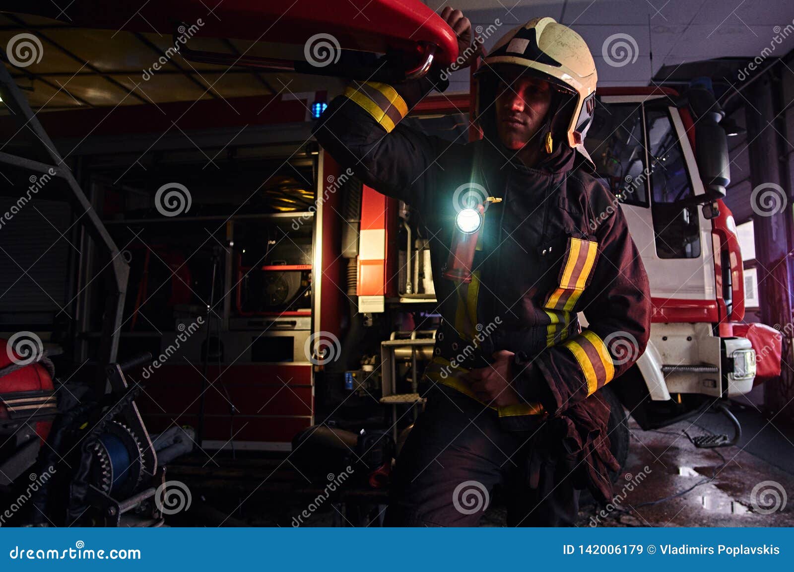 A Fireman Wearing a Protective Uniform with Flashlight Included Working ...