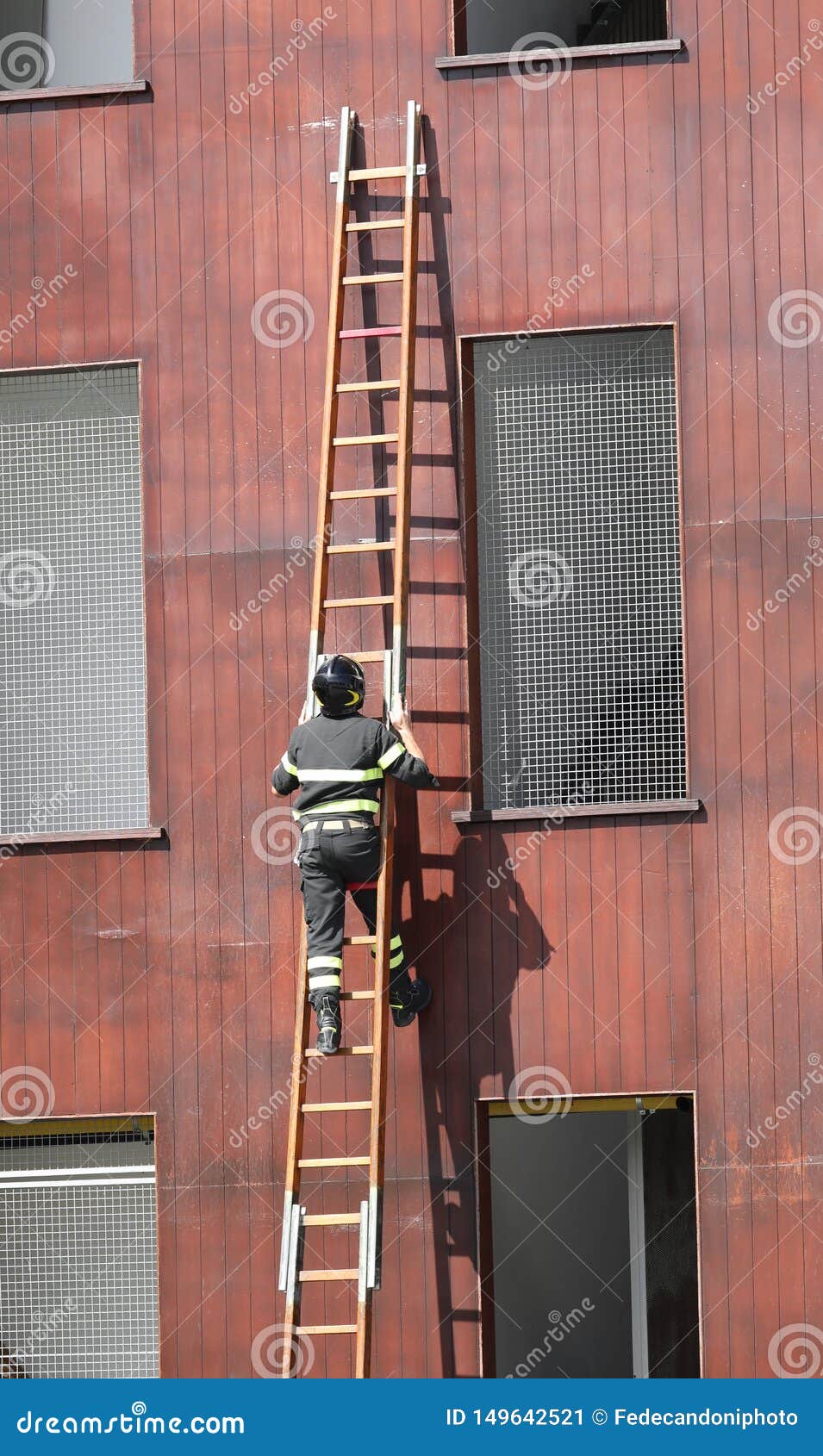 Fireman On The Wooden Ladder Editorial Photo | CartoonDealer.com #149642521
