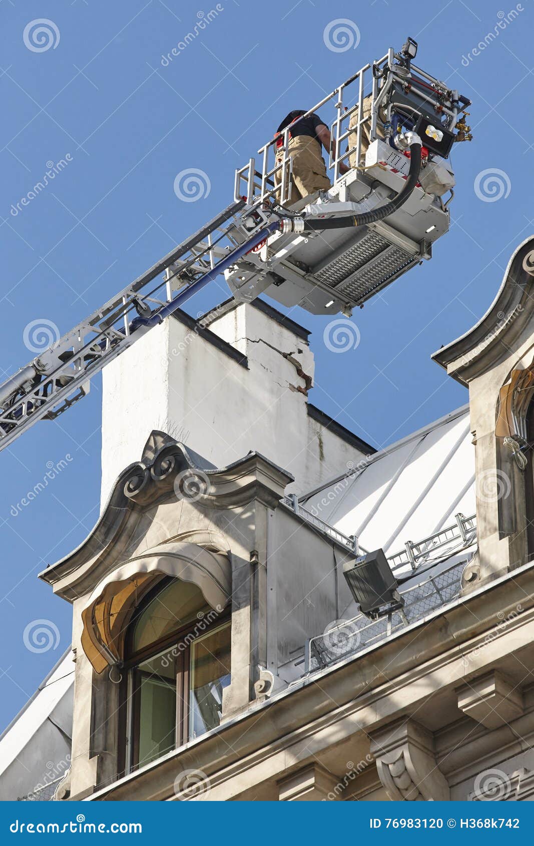 Firemen on a Crane Fixing a Structural Building Fissure Stock Photo ...