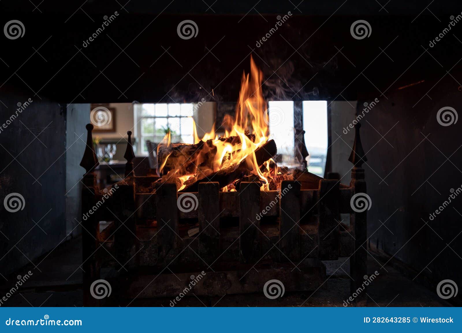 A Fireplace is Lit with Fire and Smoke Coming Out the Doors Stock Image ...
