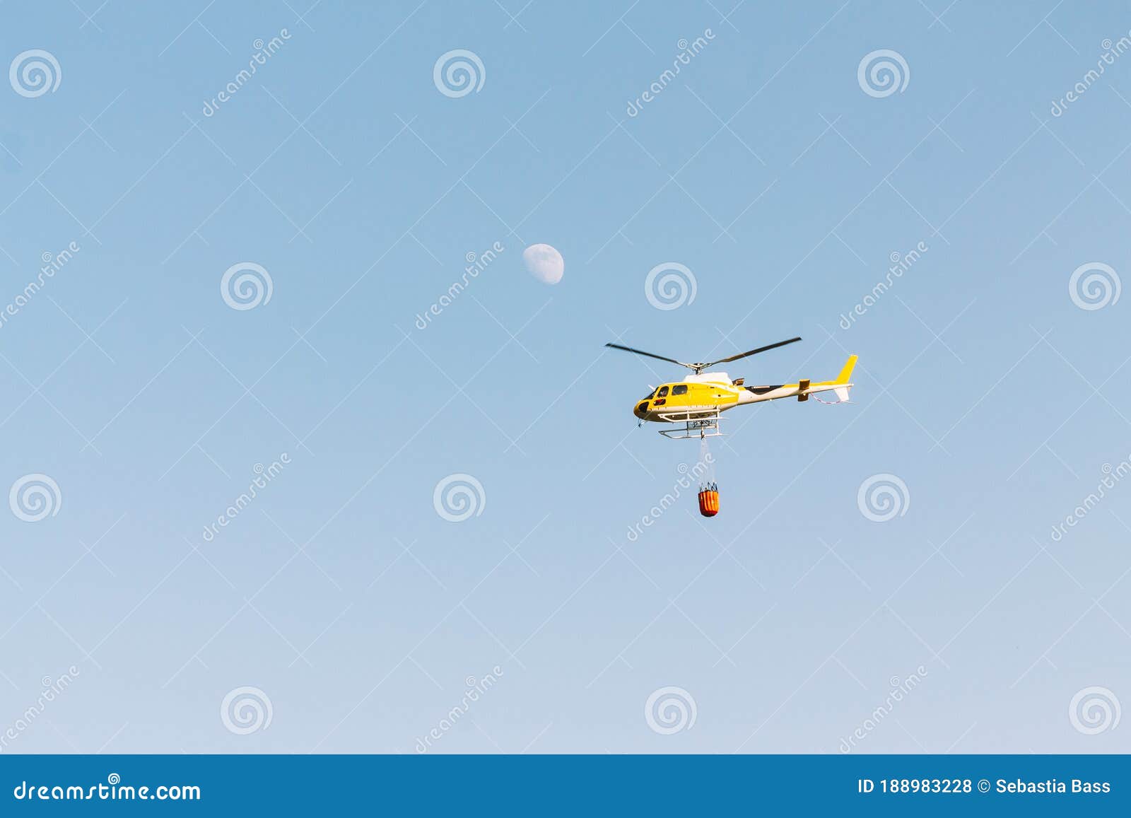 An Fires Flying with the Moon in the Mountains at Sunset. Firefighter ...