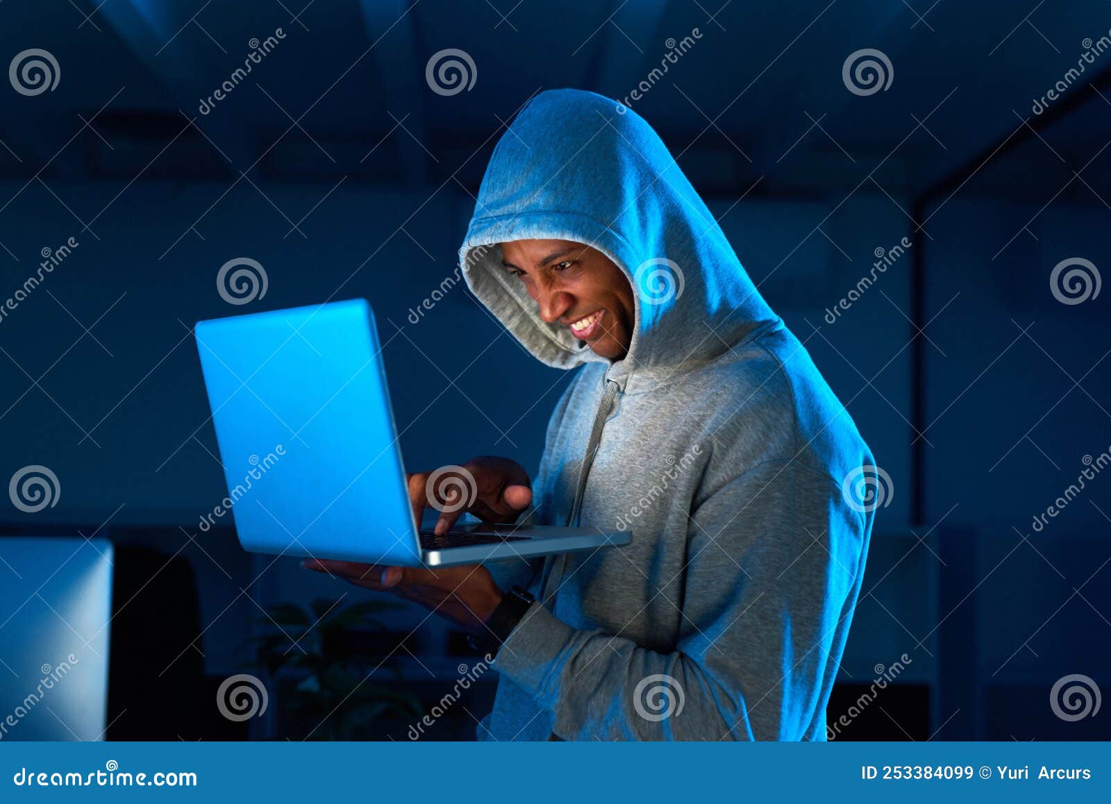 Firewall Breached. a Young Male Hacker Smiling while Using a Laptop in ...
