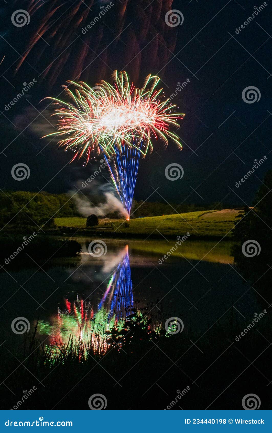 Firework Explosion Reflecting on the Water Surface Stock Photo - Image ...