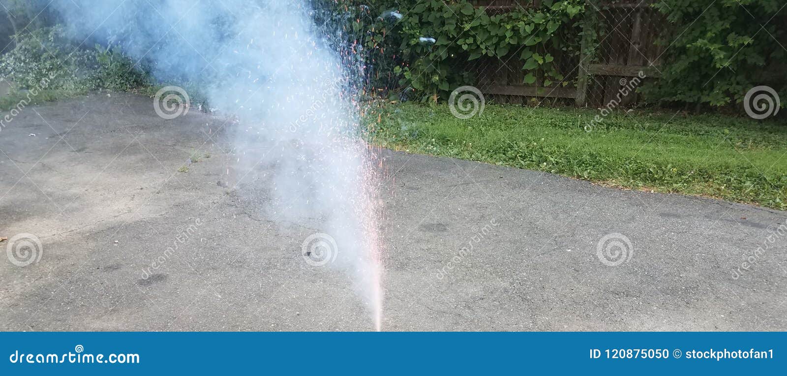 Firework or Firecracker and Sparks and Smoke in Driveway Stock Photo ...