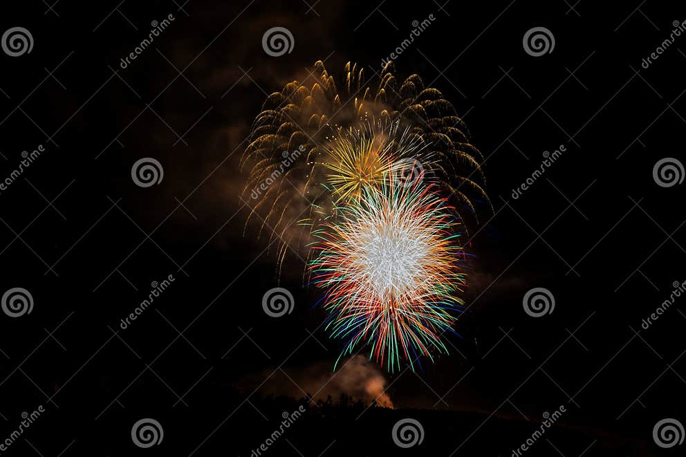 Fireworks Exploding Over the Mountains at Night in Colorado Stock Photo ...