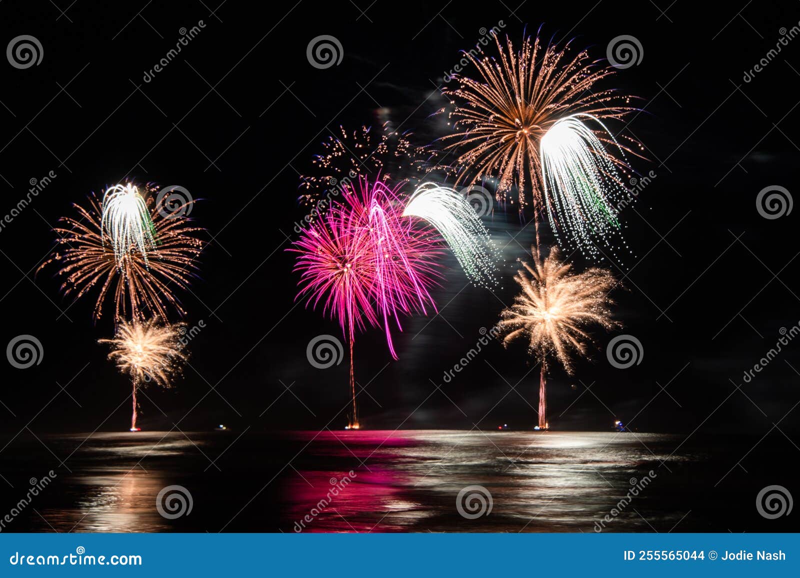 Fireworks Exploding Over the Ocean at Night Stock Photo - Image of ...