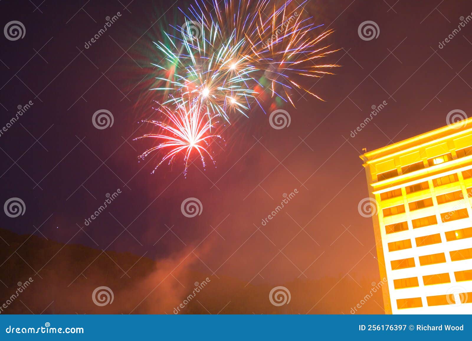 View of Fireworks Next To a Tall Building Stock Image - Image of ...