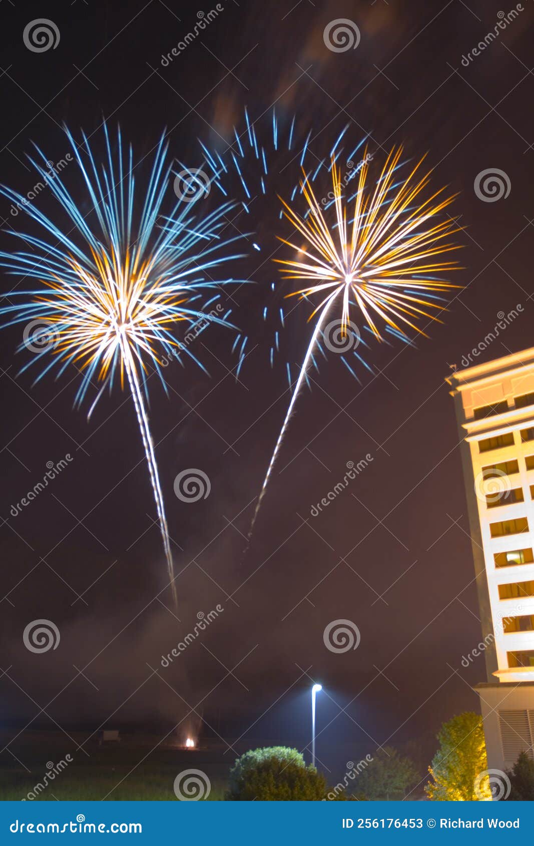View of Fireworks Next To a Tall Building Stock Image - Image of ...