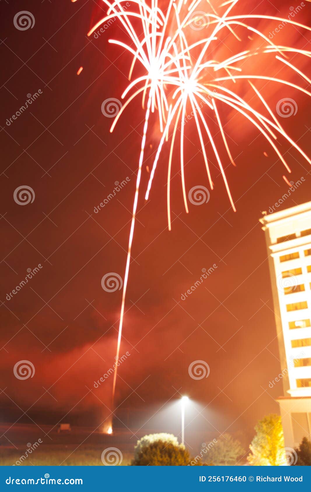 View of Fireworks Next To a Tall Building Stock Photo - Image of ...