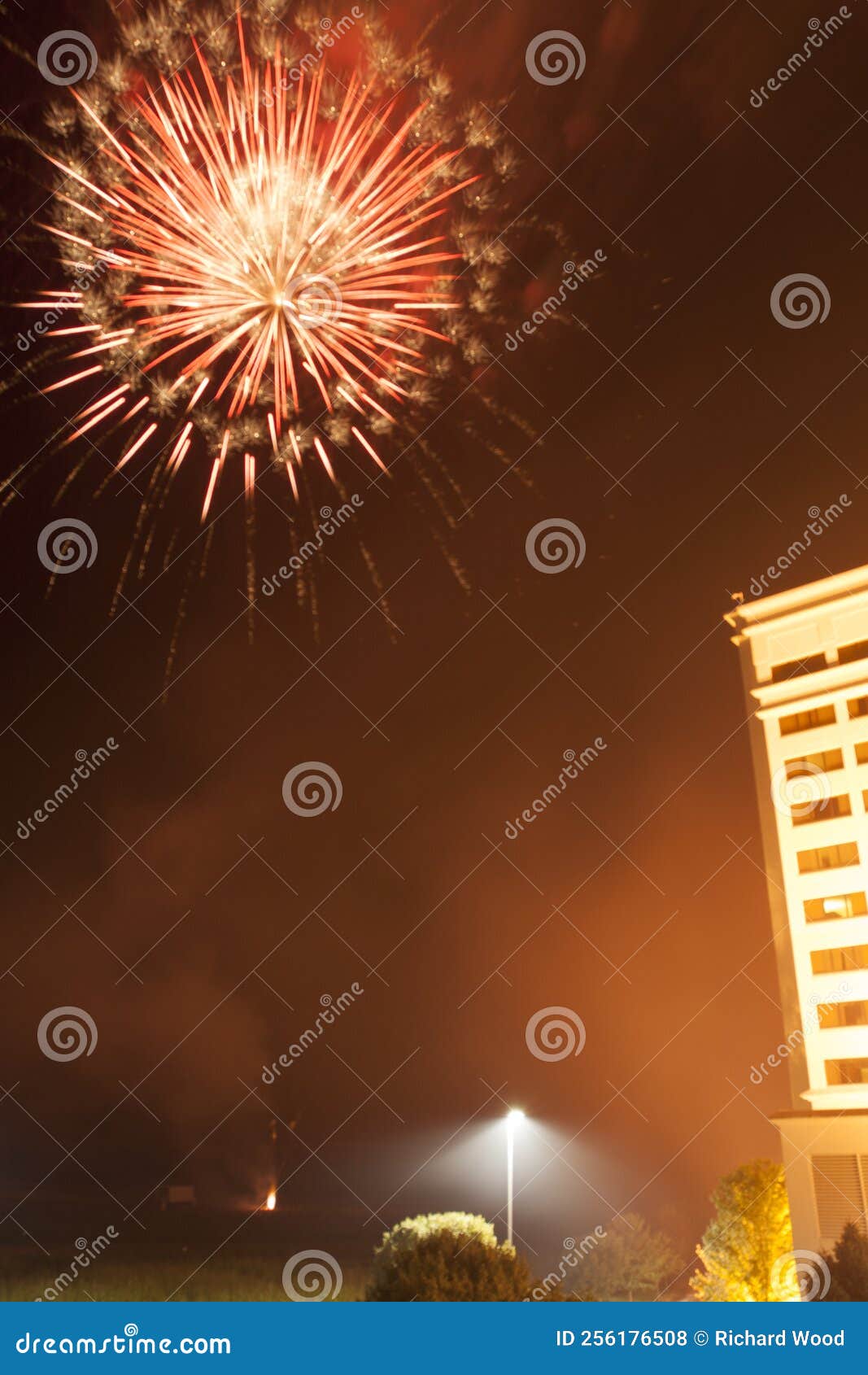 View of Fireworks Next To a Tall Building Stock Photo - Image of ...