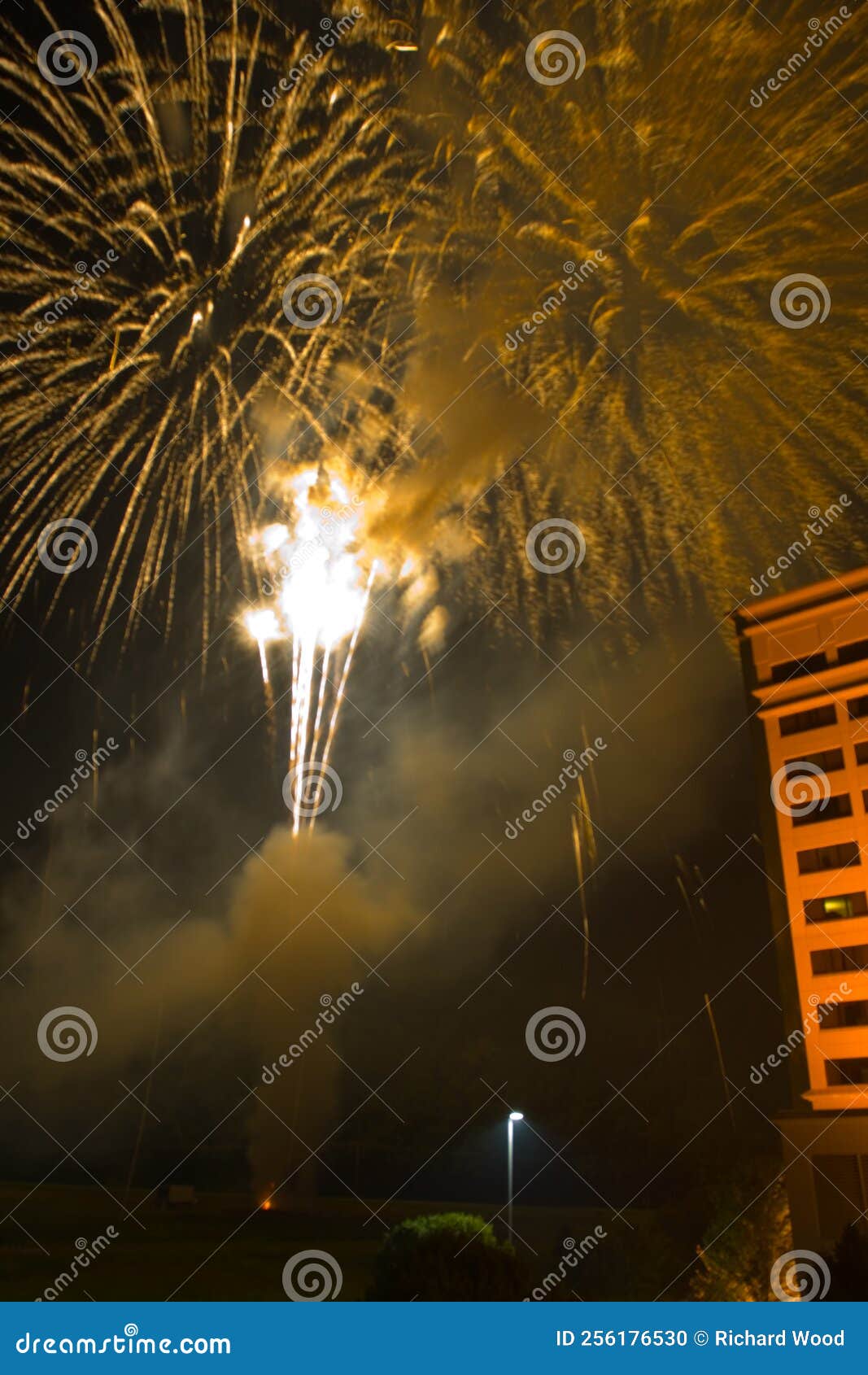 View of Fireworks Next To a Tall Building Stock Photo - Image of ...