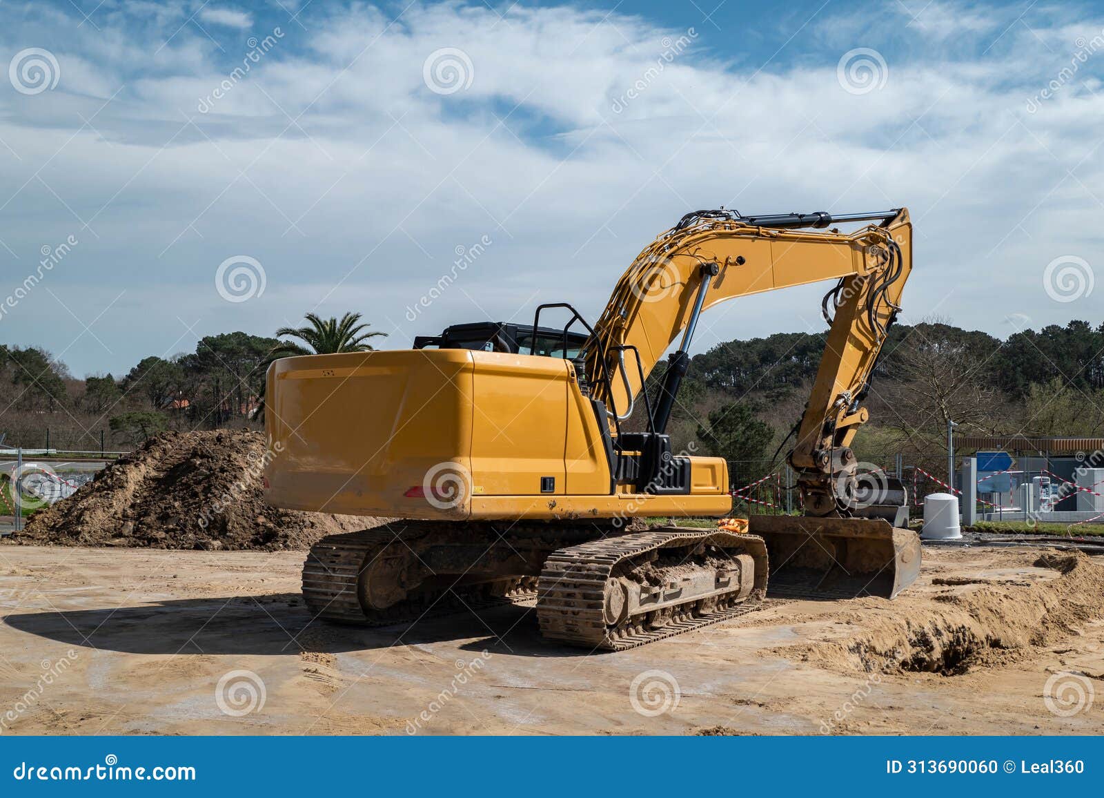 Firm Foundations: Backhoe Prepares the Land for Construction Stock ...