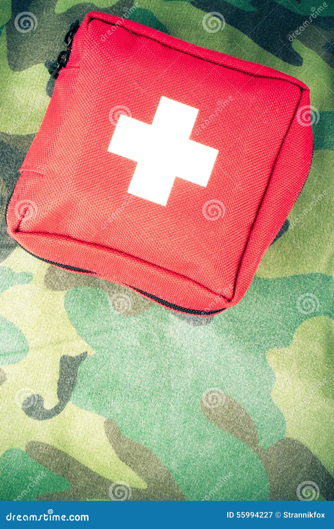 First Aid Kit on a Fabric with Camouflage Pattern. Toned Stock Image ...