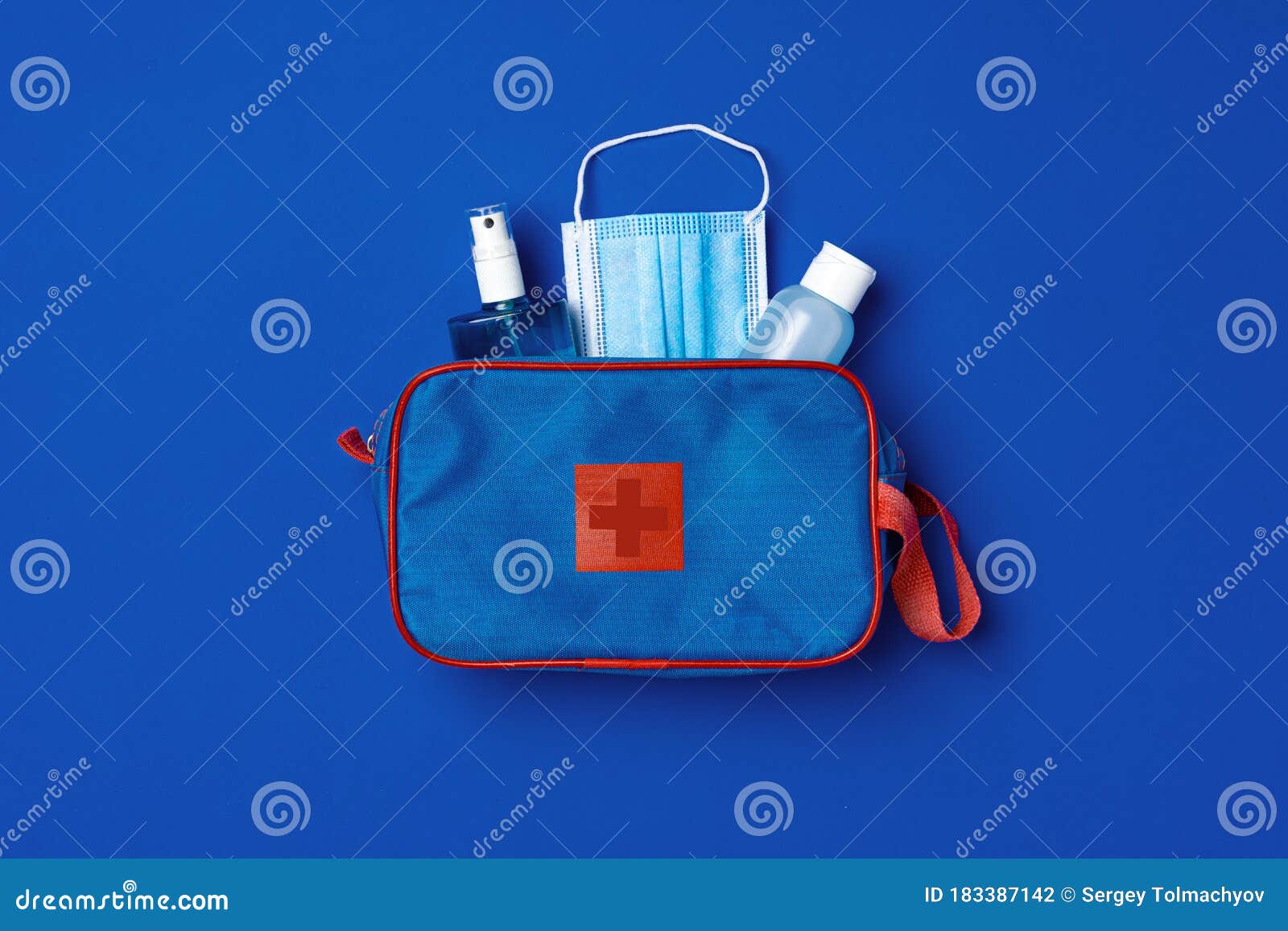 First Aid Kit with Mask and Sanitizer on Blue Background Stock Photo ...