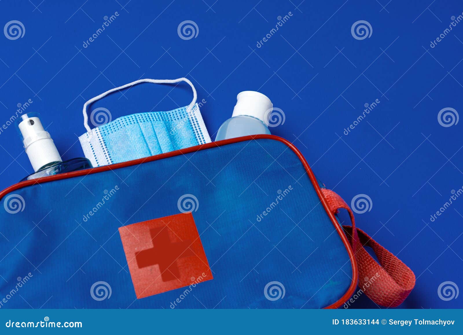 First Aid Kit with Mask and Sanitizer on Blue Background Stock Photo ...