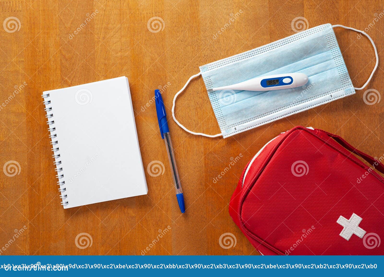 A First Aid Kit and Medical Devices Lie on the Table Next To a Notepad ...