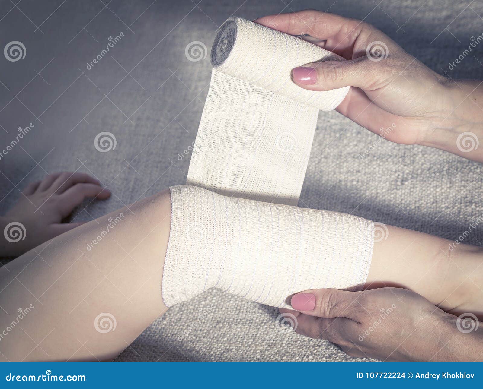 First aid at knee trauma. stock photo. Image of closedup - 107722224