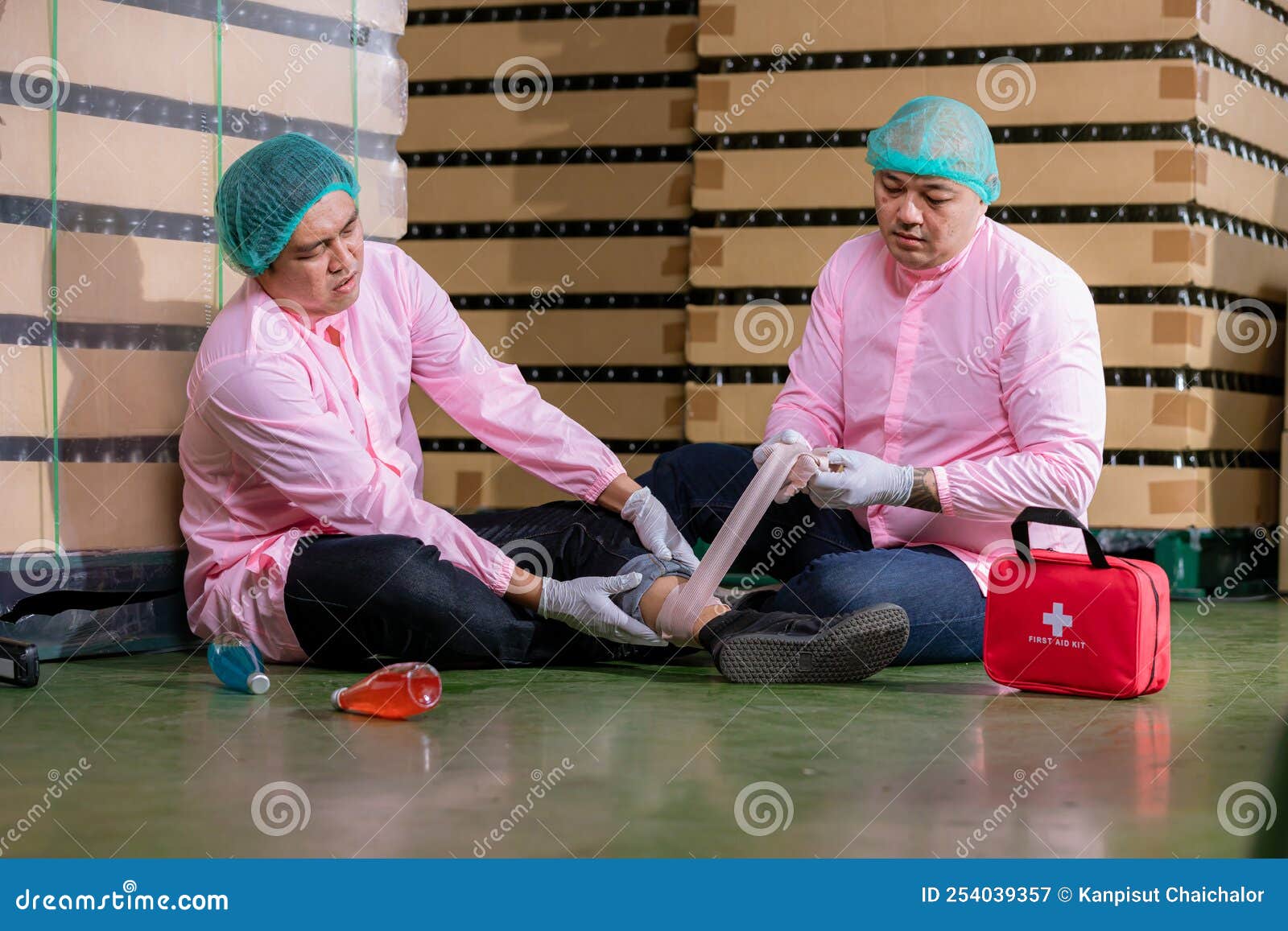 First Aid Support Accident at Work of Worker at Factory. Male Worker ...