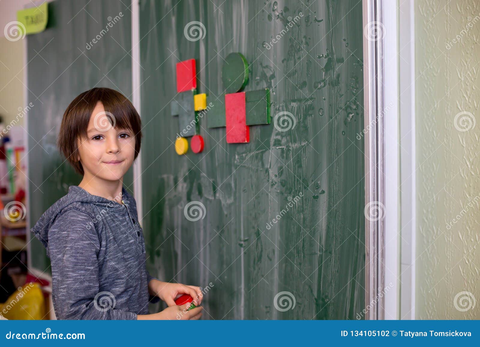 First Grade Child, Learning Math, Shapes and Colors at School Stock ...