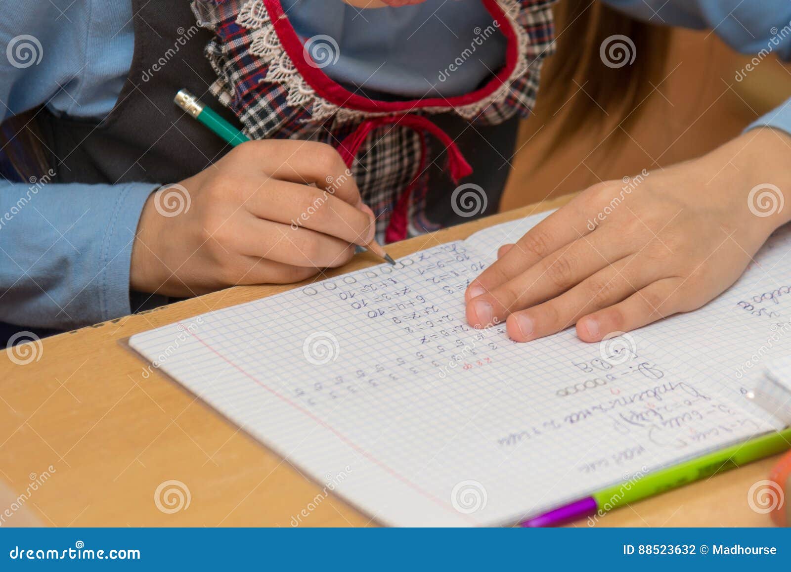 First-grader at a Lesson Mathematics Writes in the Notebook, Close-up ...
