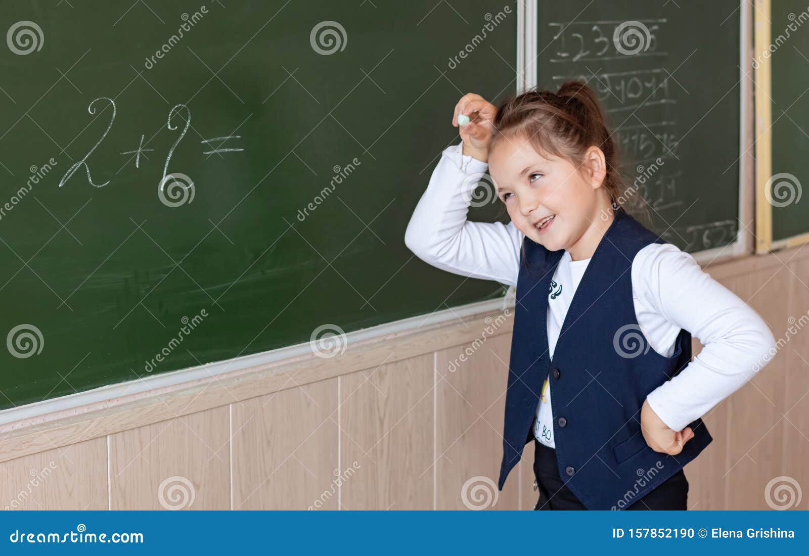 A First Grader Stands at the Blackboard and Solves an Example in ...