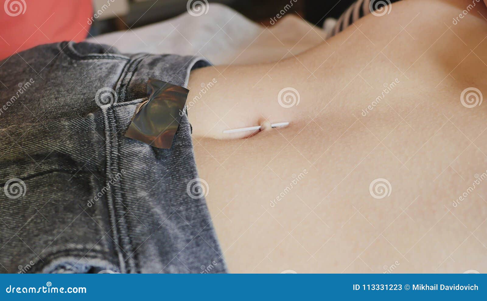 The First Piercing. Dressing the Earrings on the Navel. Female Piercing ...
