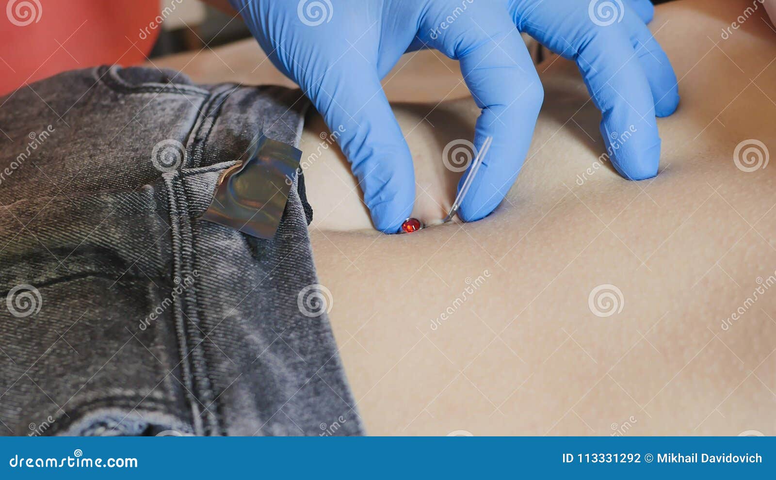 The First Piercing. Dressing the Earrings on the Navel. Female Piercing ...