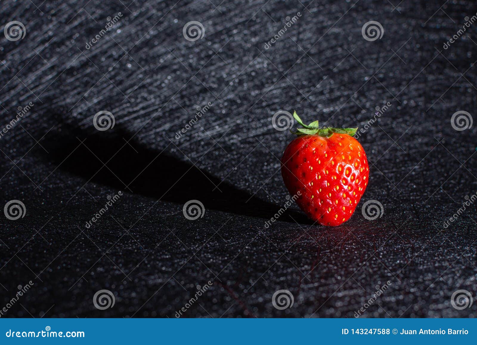 STRAWBERRY PROJECTING ITS SHADOW ISOLATED in BACKGROUND with BLACK ...